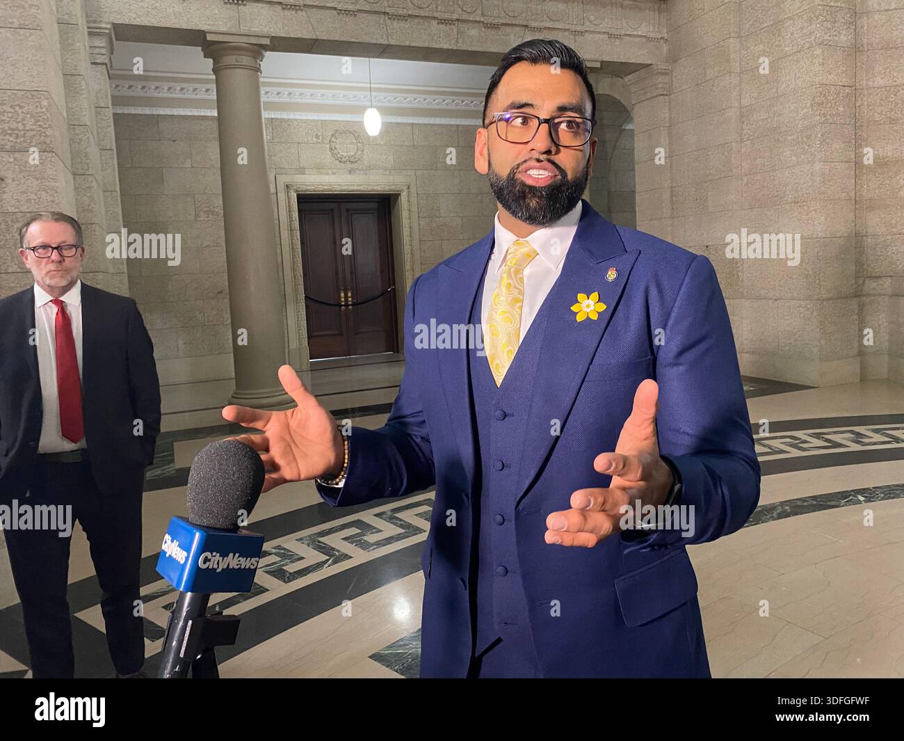 Obby Khan speaks to reporters after being sworn in as a member of the ...