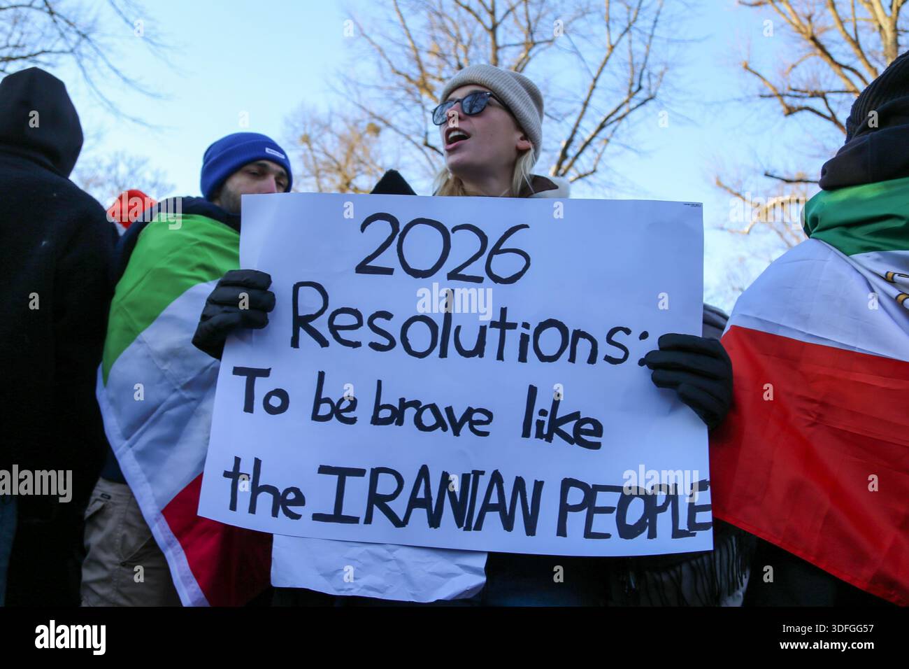 Berlin, Germany. 11th Jan, 2026. Demonstrators hold placards reading ...