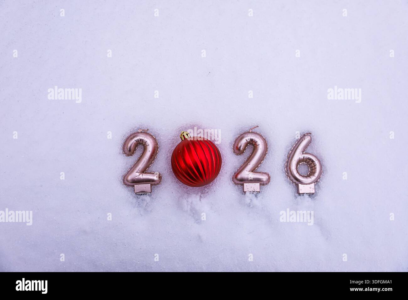 Stylish New Year 2026 winter scene with a ribbed red Christmas ornament ...