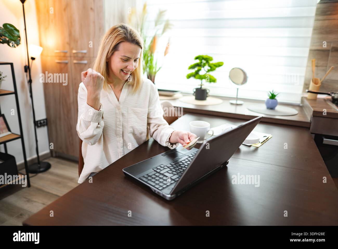 Woman celebrates success working hi-res stock photography and images ...