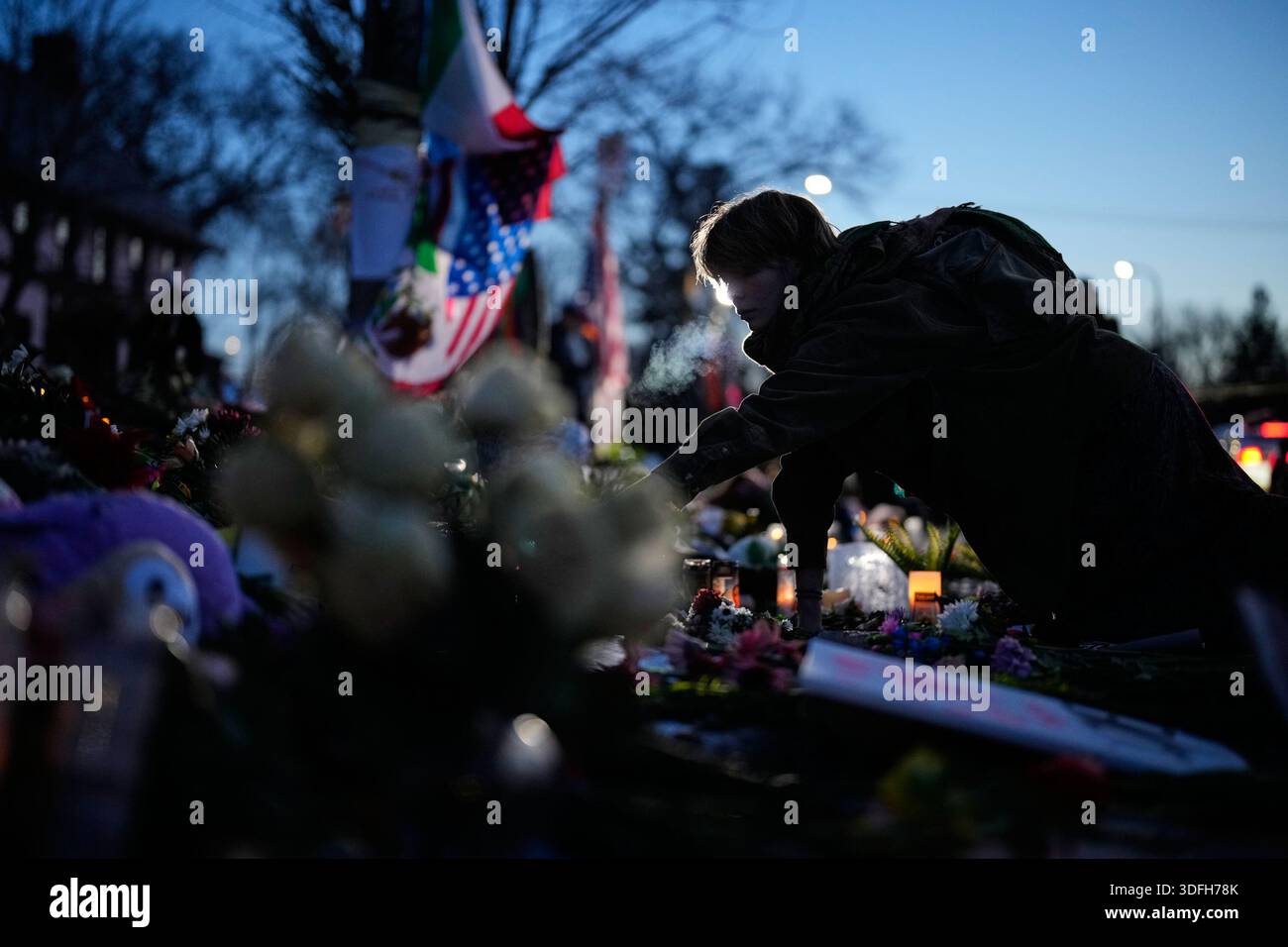Lydia Meier lights candles while visiting a makeshift memorial for ...