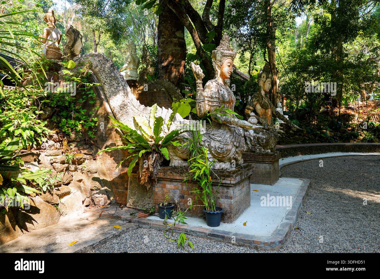 Intricate four-armed deity statue at the Wat Pha Lat forest temple in ...