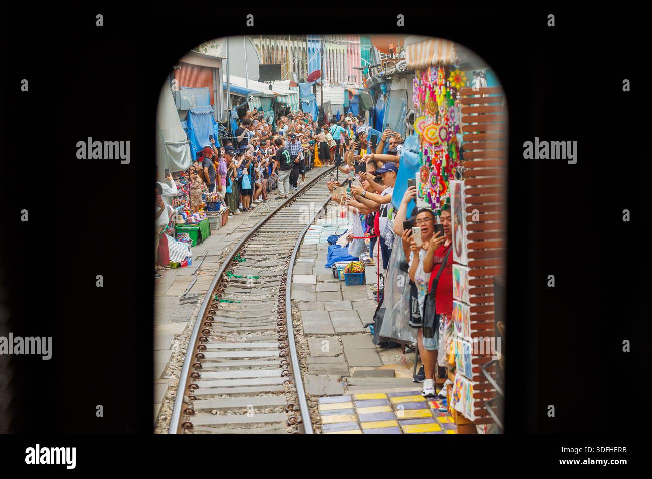Samut Songkhram, June 14, 2025. Tourists watch and take photos along ...