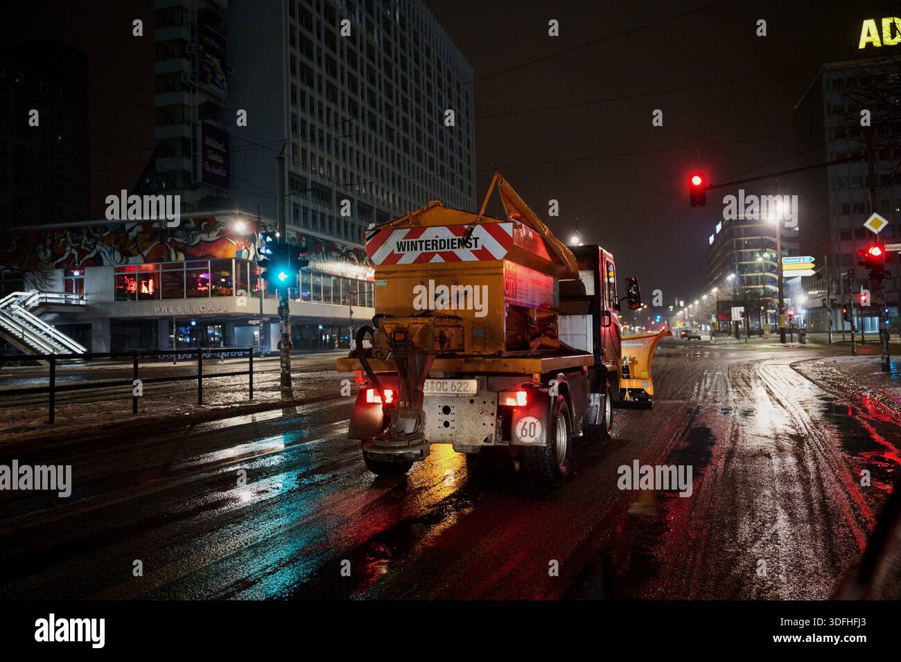 A BSR gritting vehicle grits at Brandenbuger Tor while it rains and ...