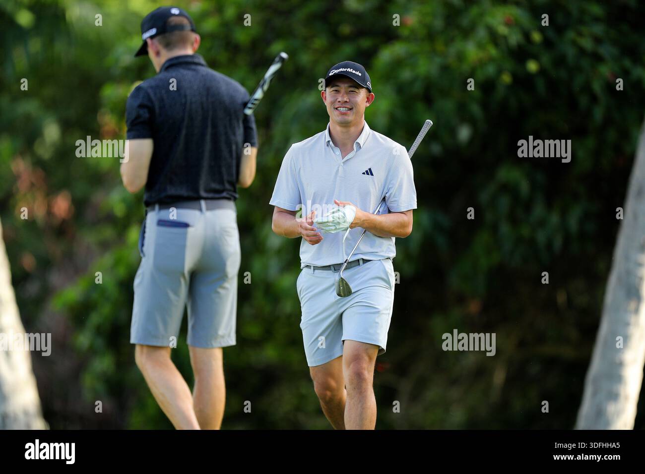 January 12, 2026 - Collin Morikawa chats with his caddie Mark Urbanek ...