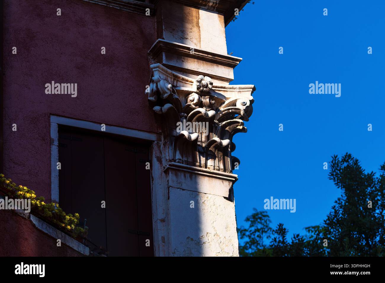 Ornate Corinthian column capital stands prominently against sky ...
