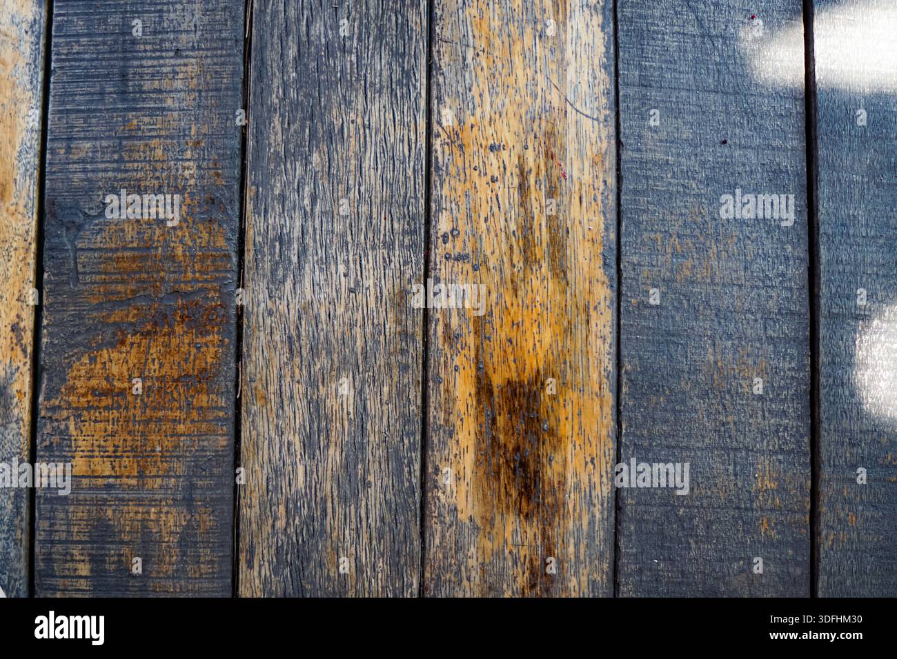 Close-up of aged vertical wood planks with exposed grain, wear marks ...