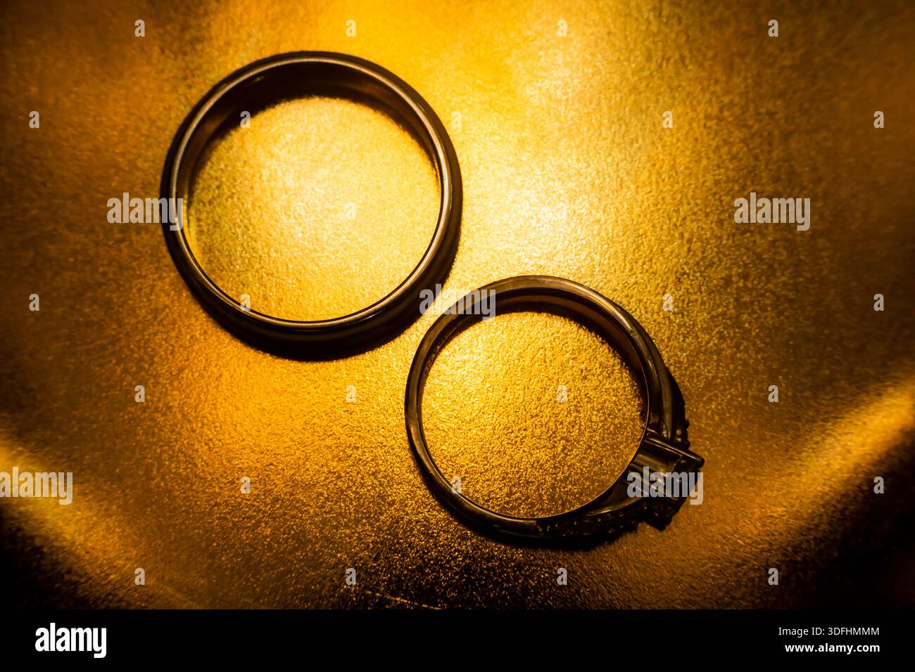 Wedding Rings on Golden Textured Background Stock Photo - Alamy