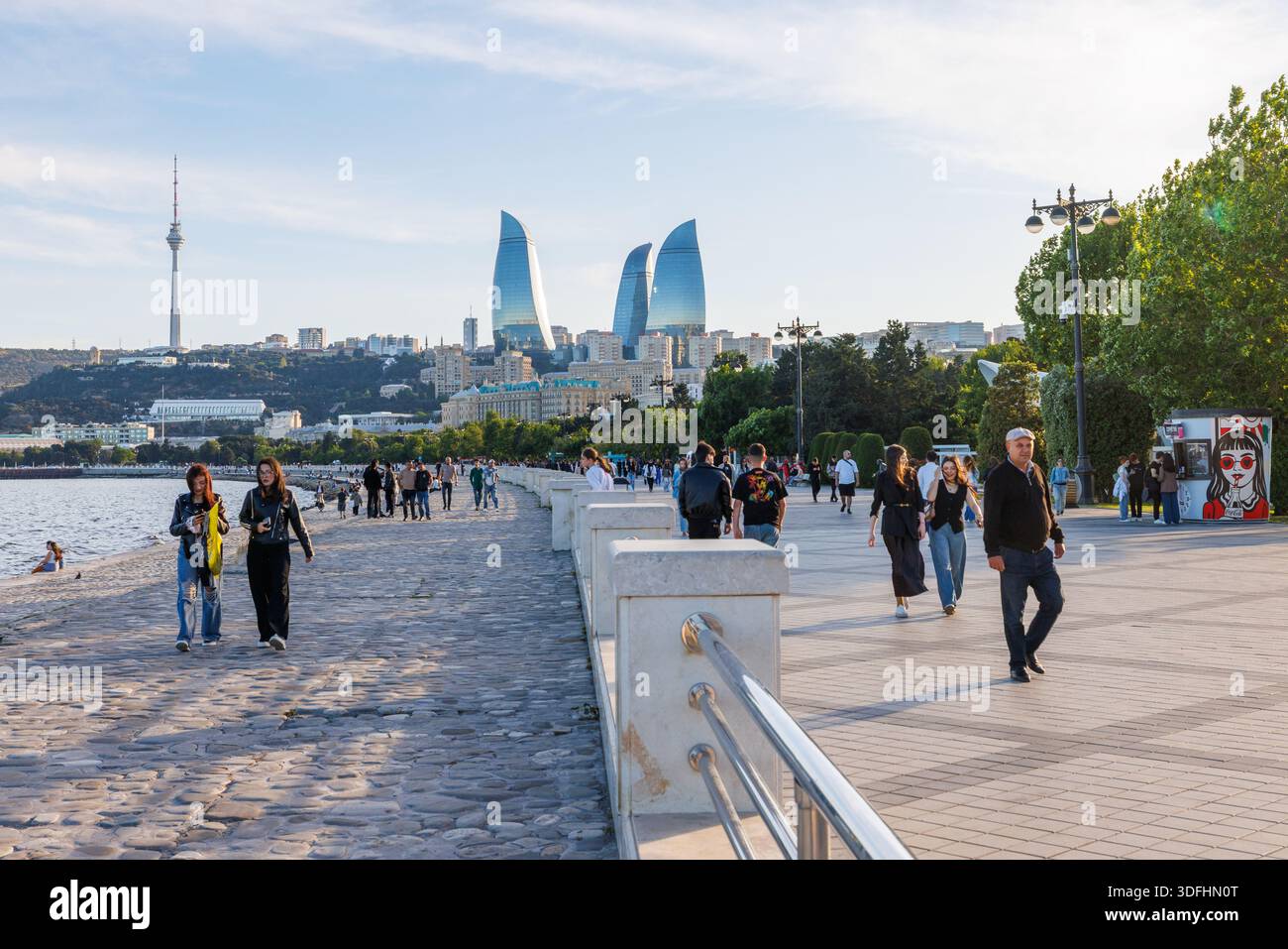 Baku, May 18, 2025, Tourists walk along the Baku Promenade with the ...