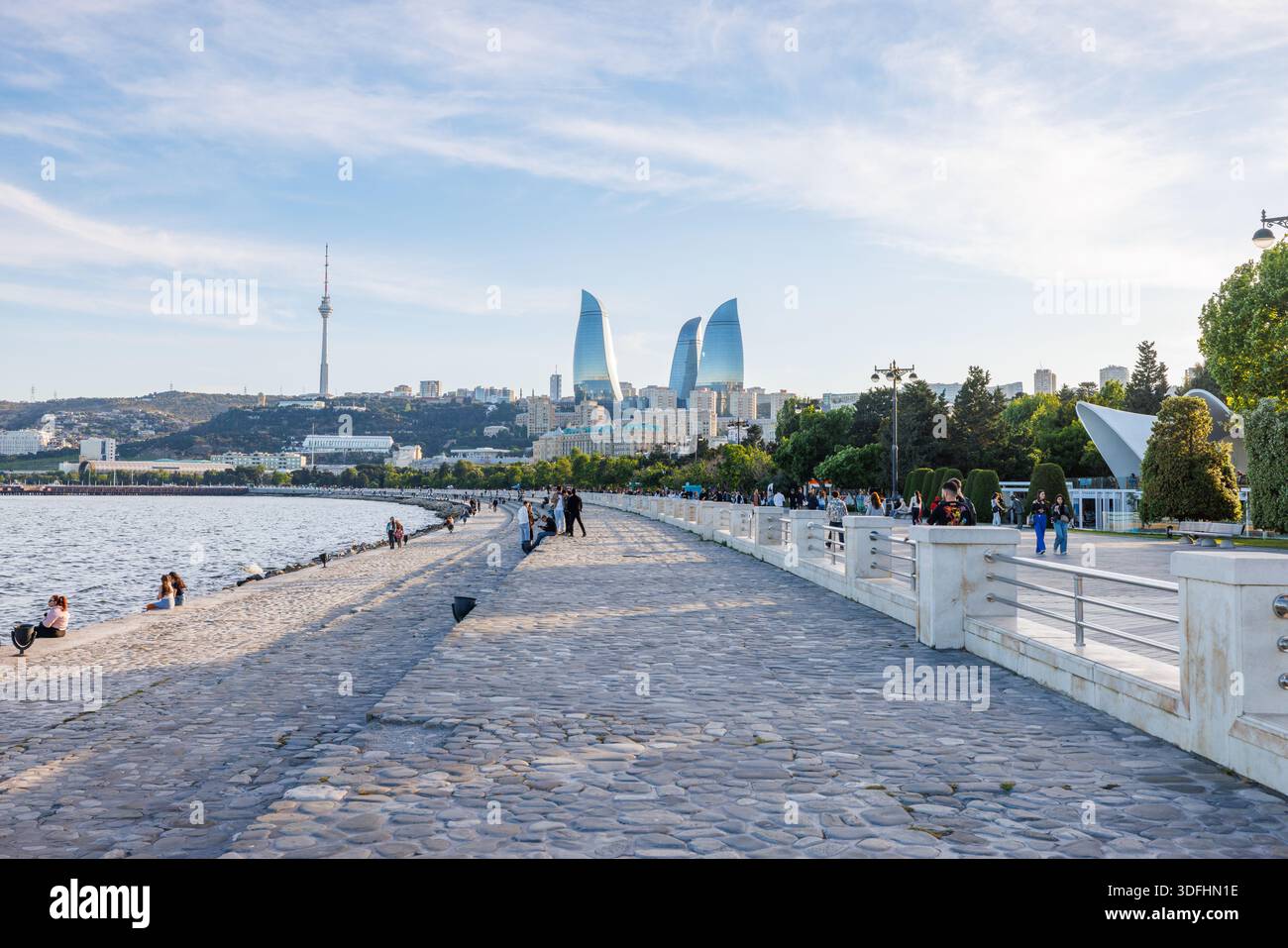 Baku, May 18, 2025, Tourists walk along the Baku Promenade with the ...