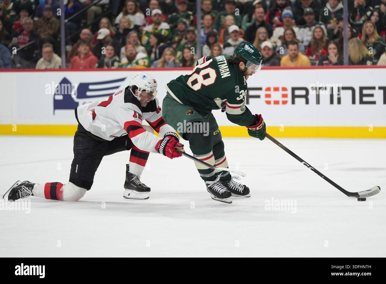 Minnesota Wild right wing Ryan Hartman (38) skates with the puck as New ...