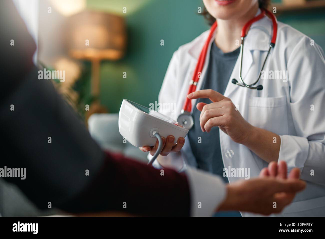 Doctor is measuring blood pressure to a senior woman Stock Photo - Alamy