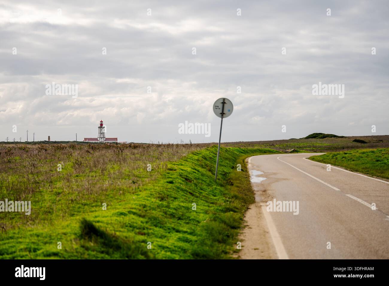 Sesimbra Portugal December 25 2025. A narrow paved road curves through ...
