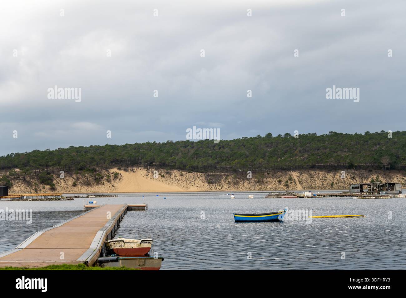 Sesimbra Portugal December 25 2025. Wooden pier and small boats sit on ...