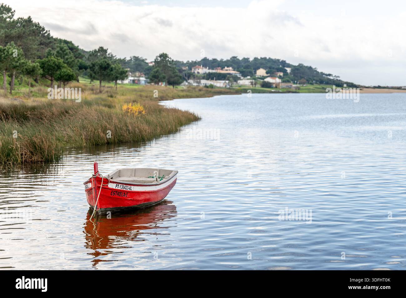 Sesimbra Portugal December 25 2025. A red fishing boat floats on calm ...