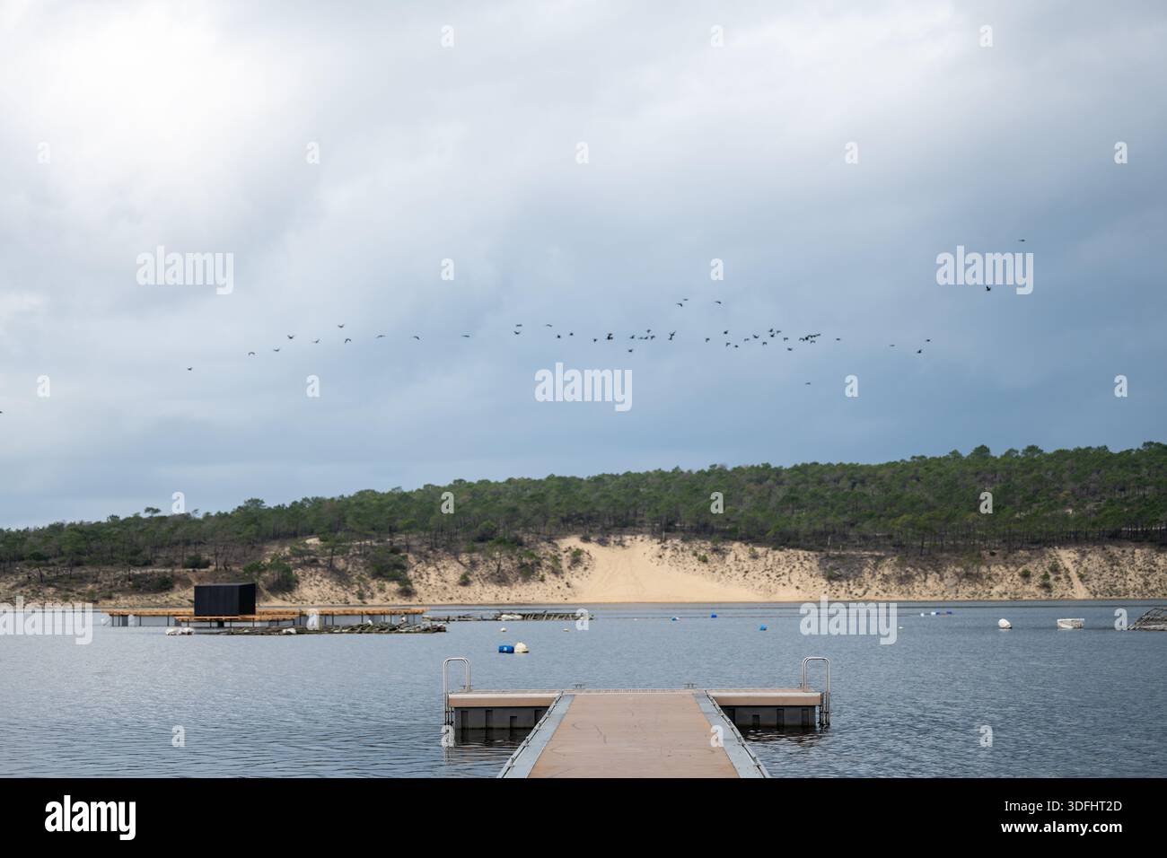 Sesimbra Portugal December 25 2025. A wooden pier extends into lagoon ...