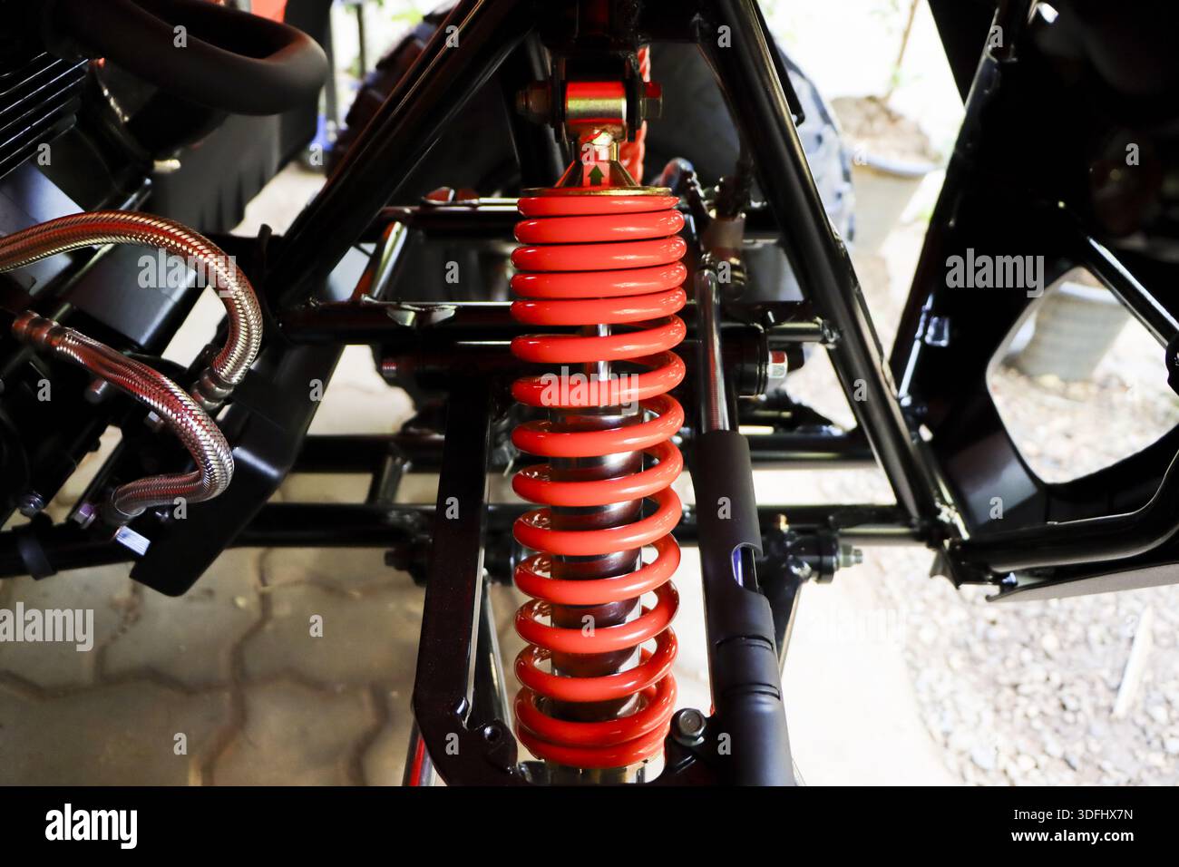 Detailed view of clean red shock absorber spring suspension system ...