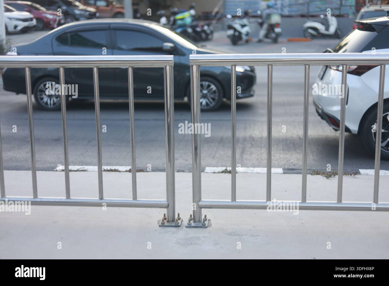 Shiny stainless steel railing fence barrier standing firm concrete ...