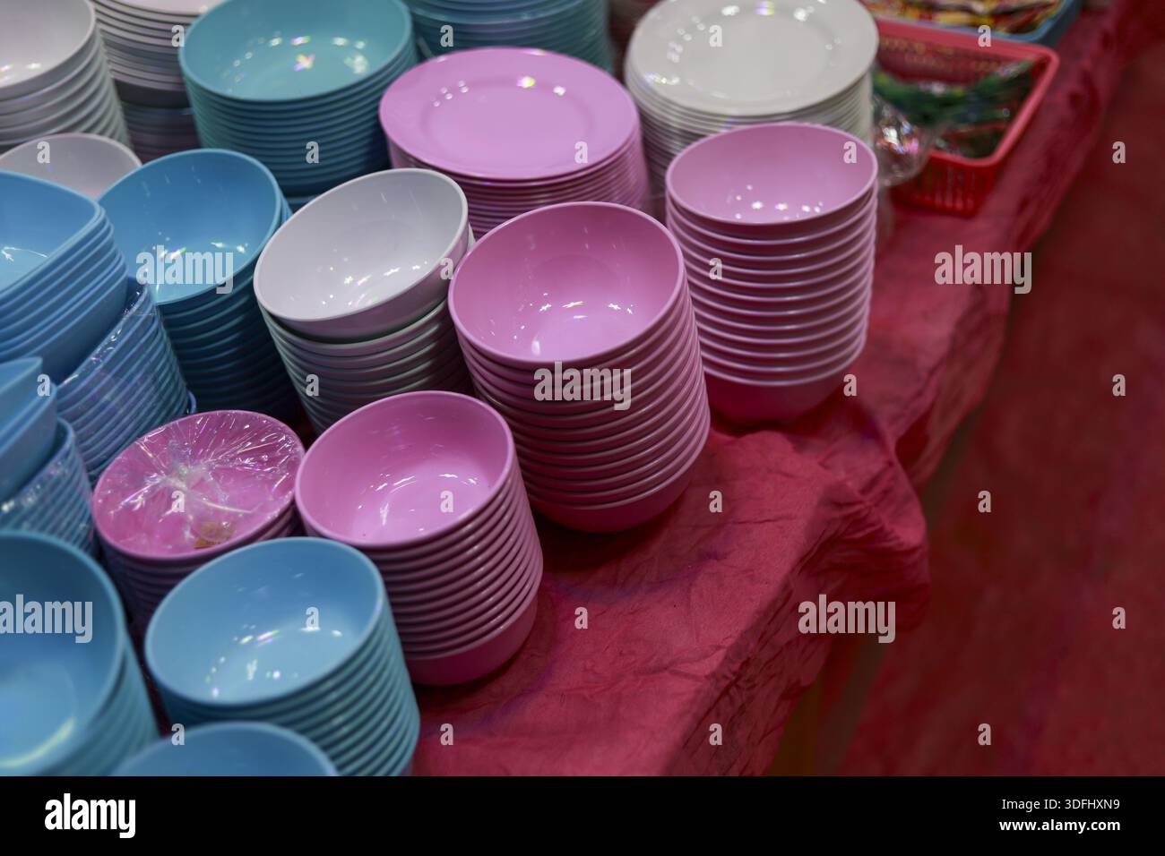 Stacks of pink and blue plastic bowl piles on table with cheerful ...