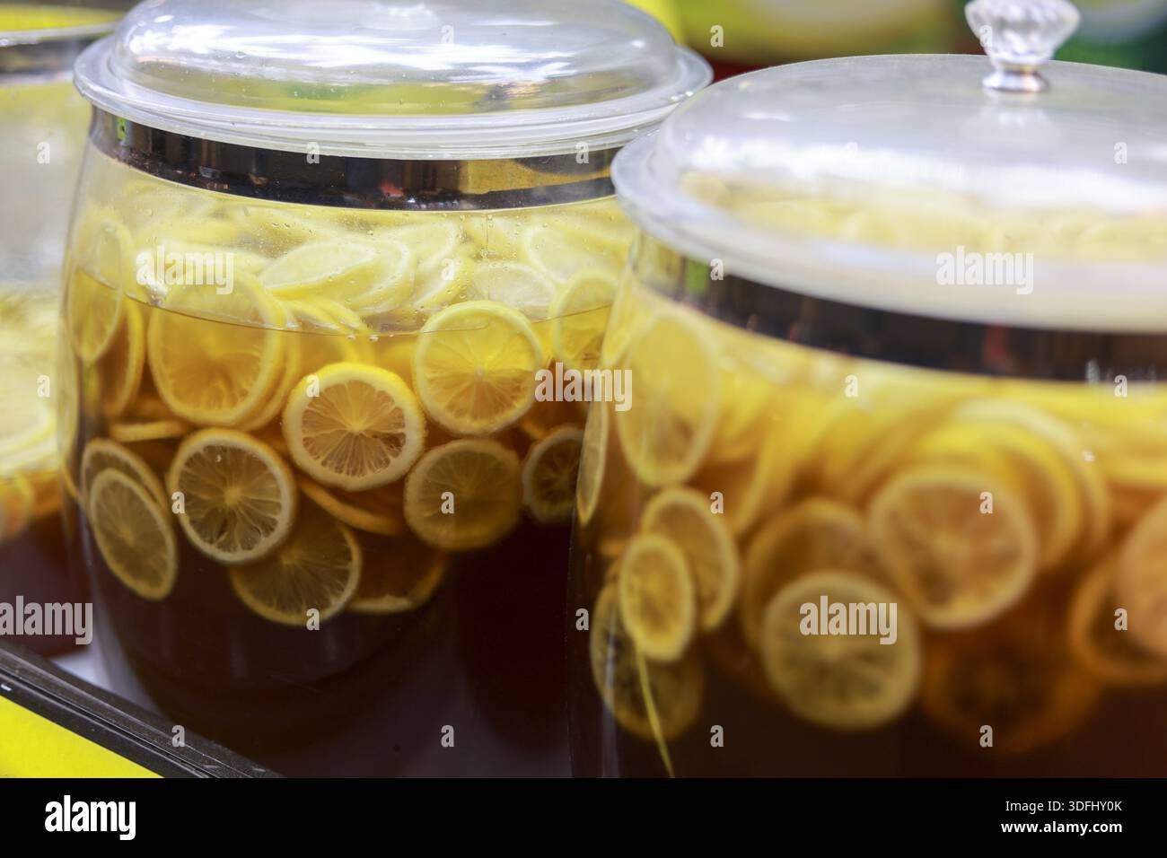 Refreshing drink dispenser with glass jar container full of yellow ...