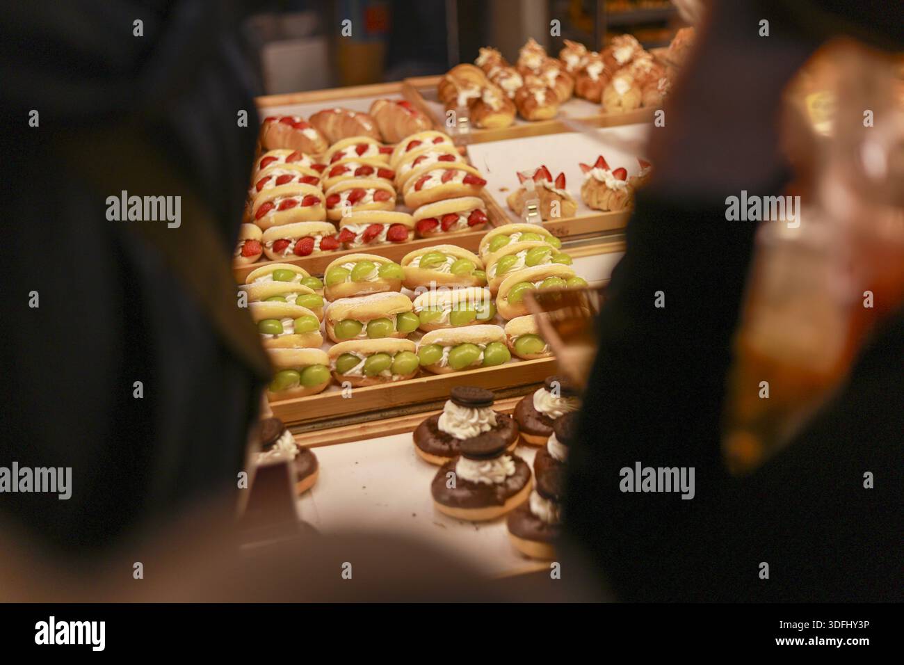 Delicious fresh pastry and sweet dessert displayed in bakery shop ...