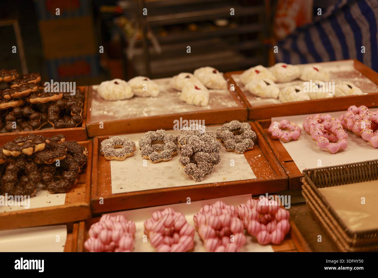 Tasty sweet donuts on wooden tray in bakery shop with sugar glazed ...