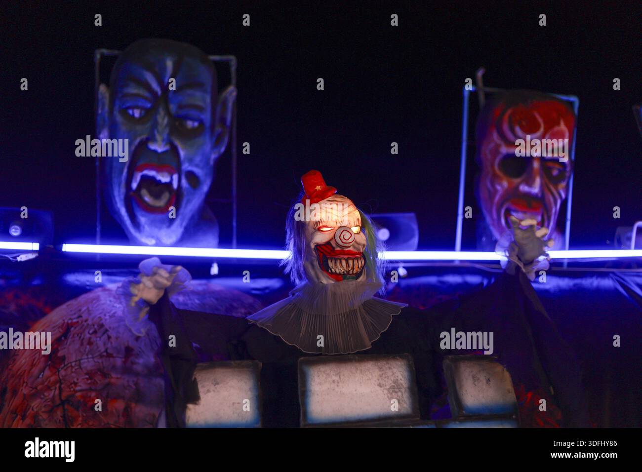 Scary halloween clown with menacing smile holding sack dark room with ...