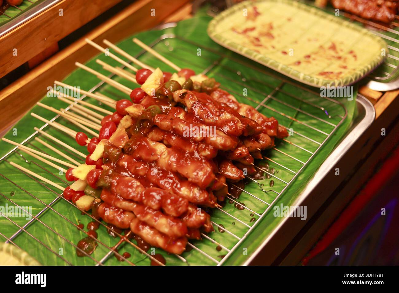Delicious looking barbecue pork skewer street food with pineapple and ...