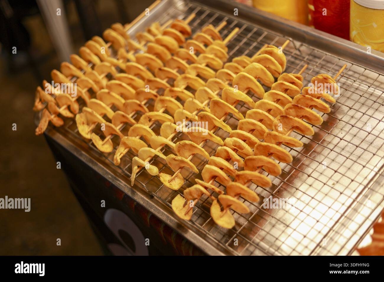 Delicious fried tornado potato spiral on skewer at street food market ...