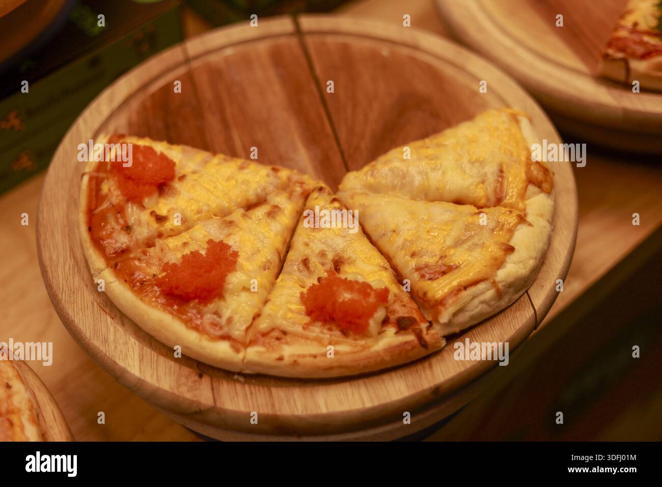 Tasty baked pizza slice with melted cheese and red tomato topping ...