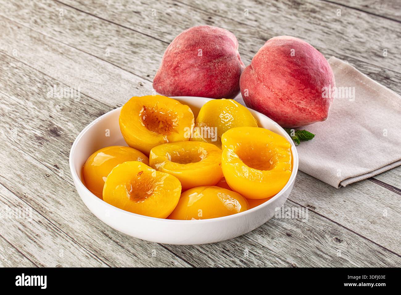 Sweet ripe yellow canned peaches pieces Stock Photo - Alamy