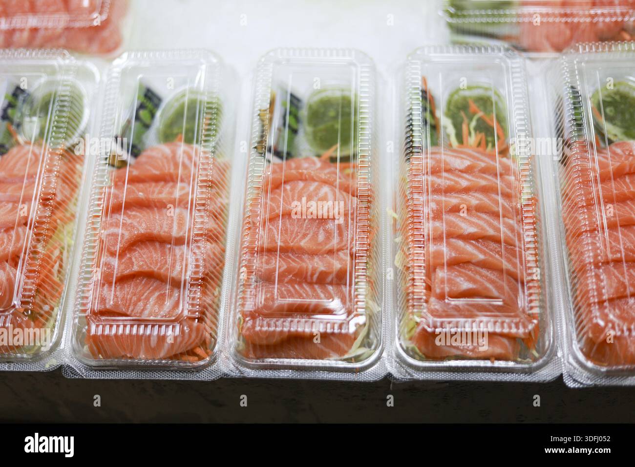 Fresh raw salmon sashimi slices in plastic box ready for take away ...