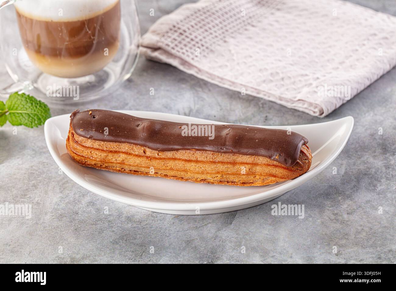 Gourmet chocolate eclair with brown icing Stock Photo - Alamy