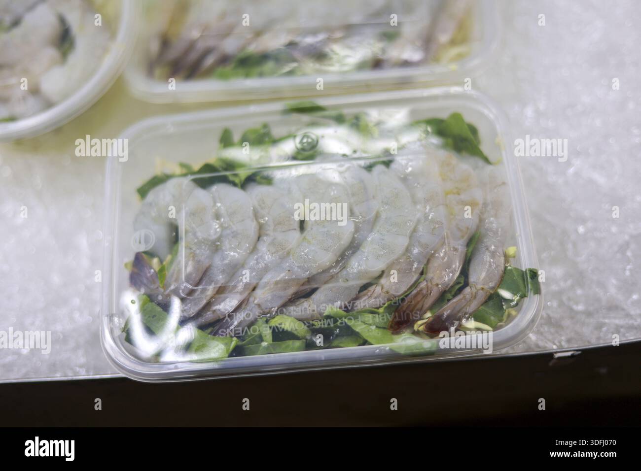 Fresh raw shrimp packaged plastic container ice seafood market ...