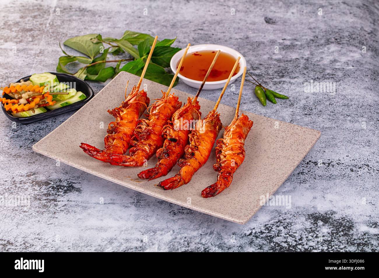 Grilled tiger prawn skewer served sauce Stock Photo - Alamy