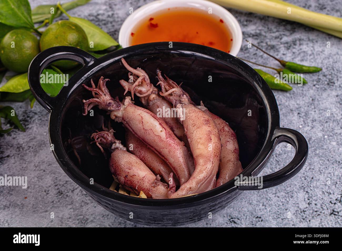 Boiled wild mini calamari snack with ginger Stock Photo - Alamy