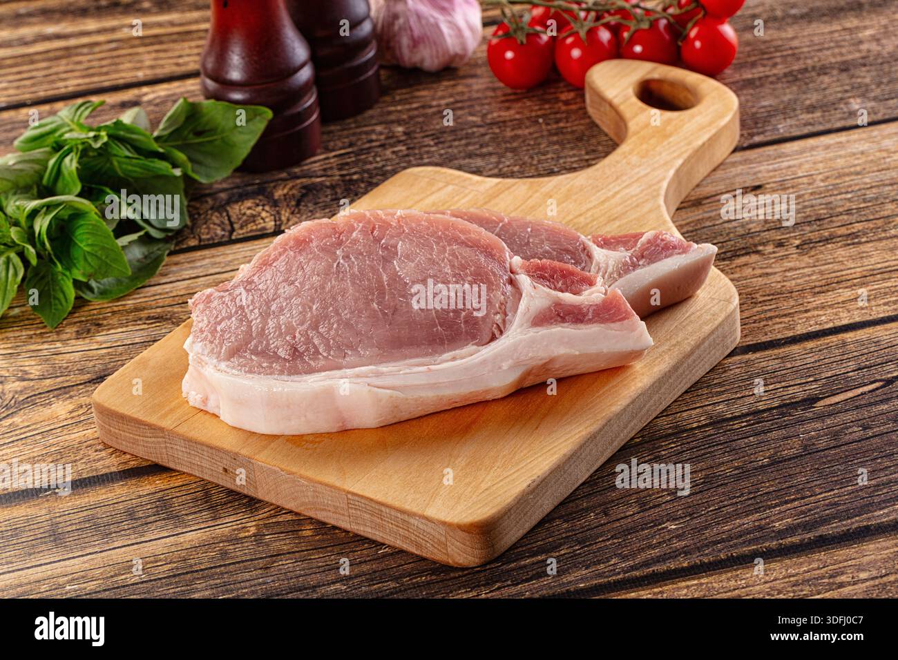 Raw pork steak over board for cooking Stock Photo - Alamy