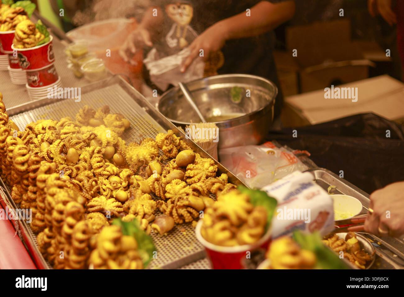 Detailed shot street food vendor cooking delicious grilled squid skewer ...
