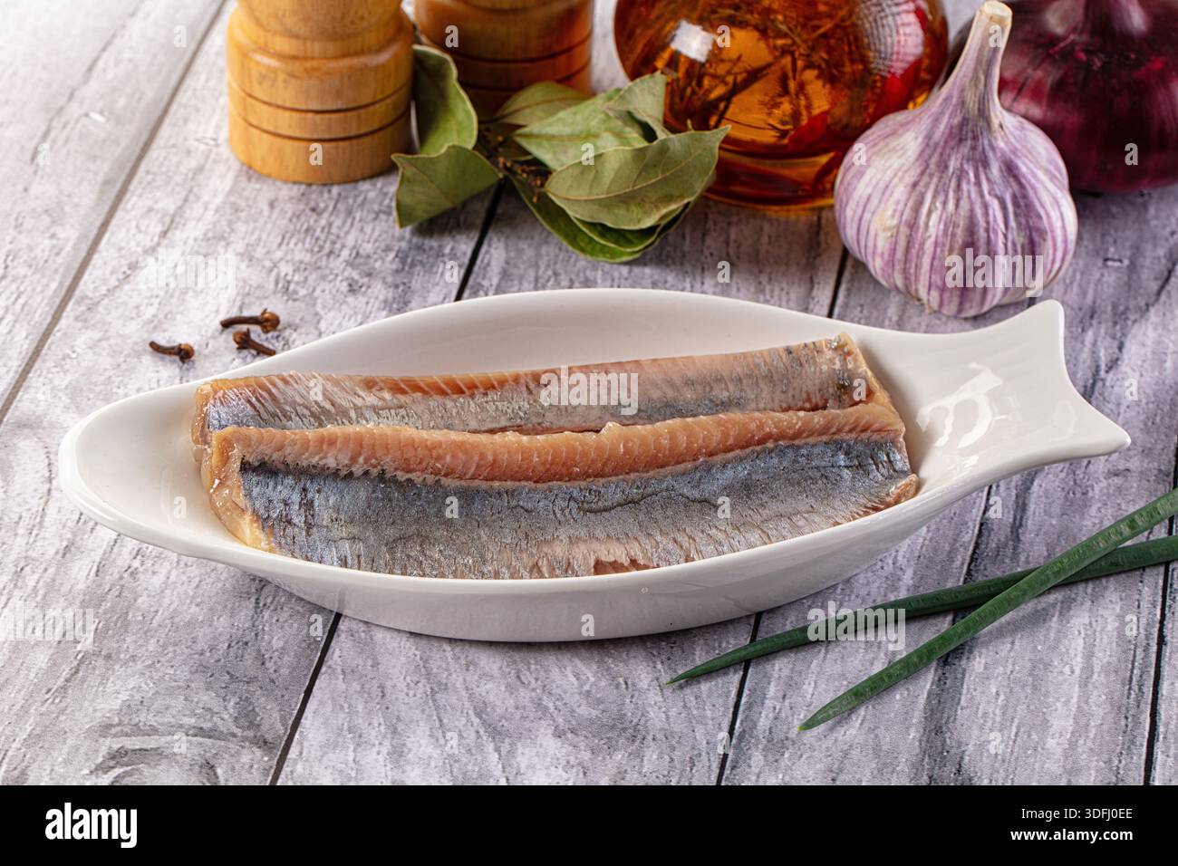 Marinated salted herring fillet slices in the plate Stock Photo - Alamy