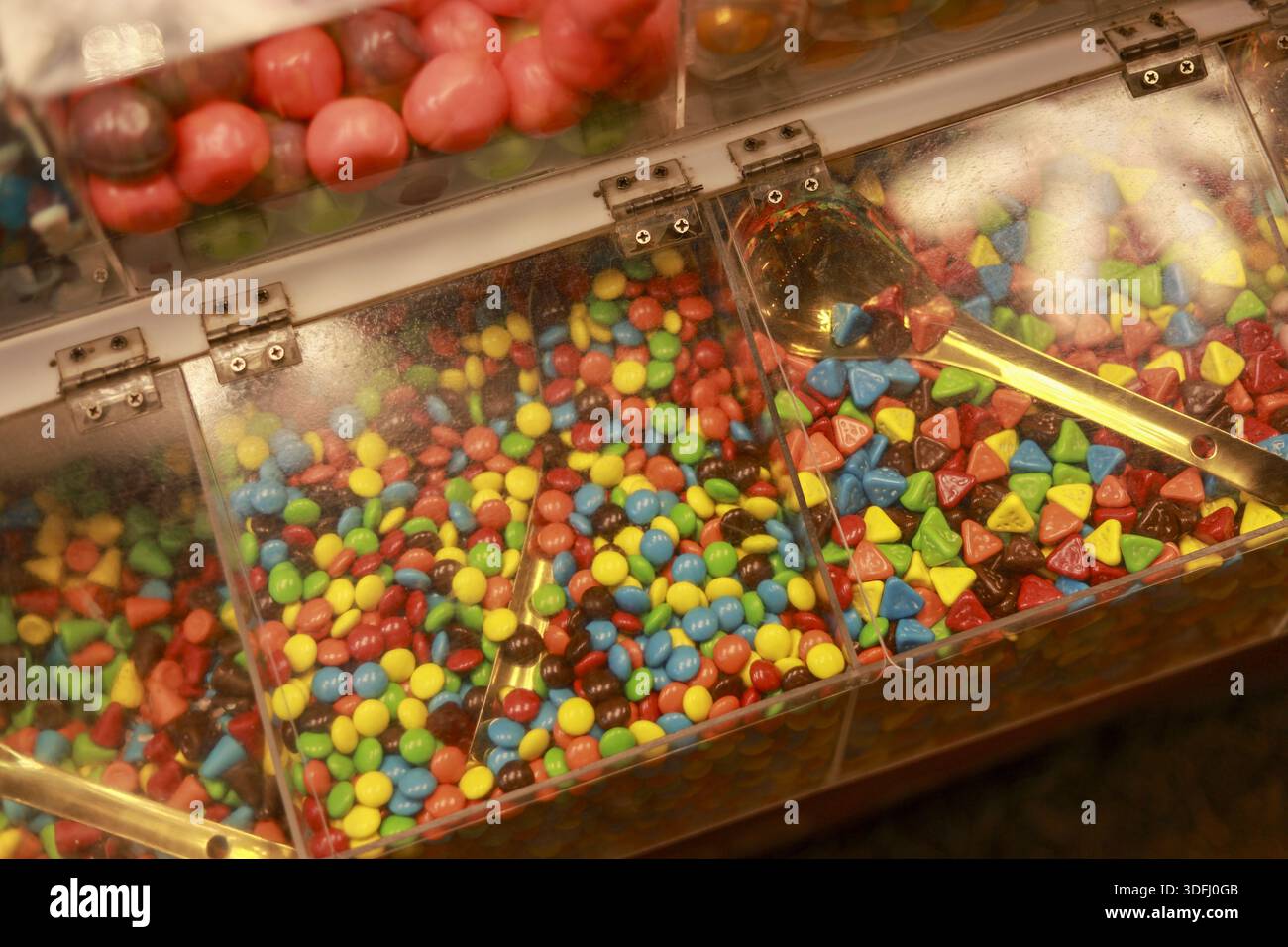 Colorful candy bin display featuring assortment of sweet chocolate ...