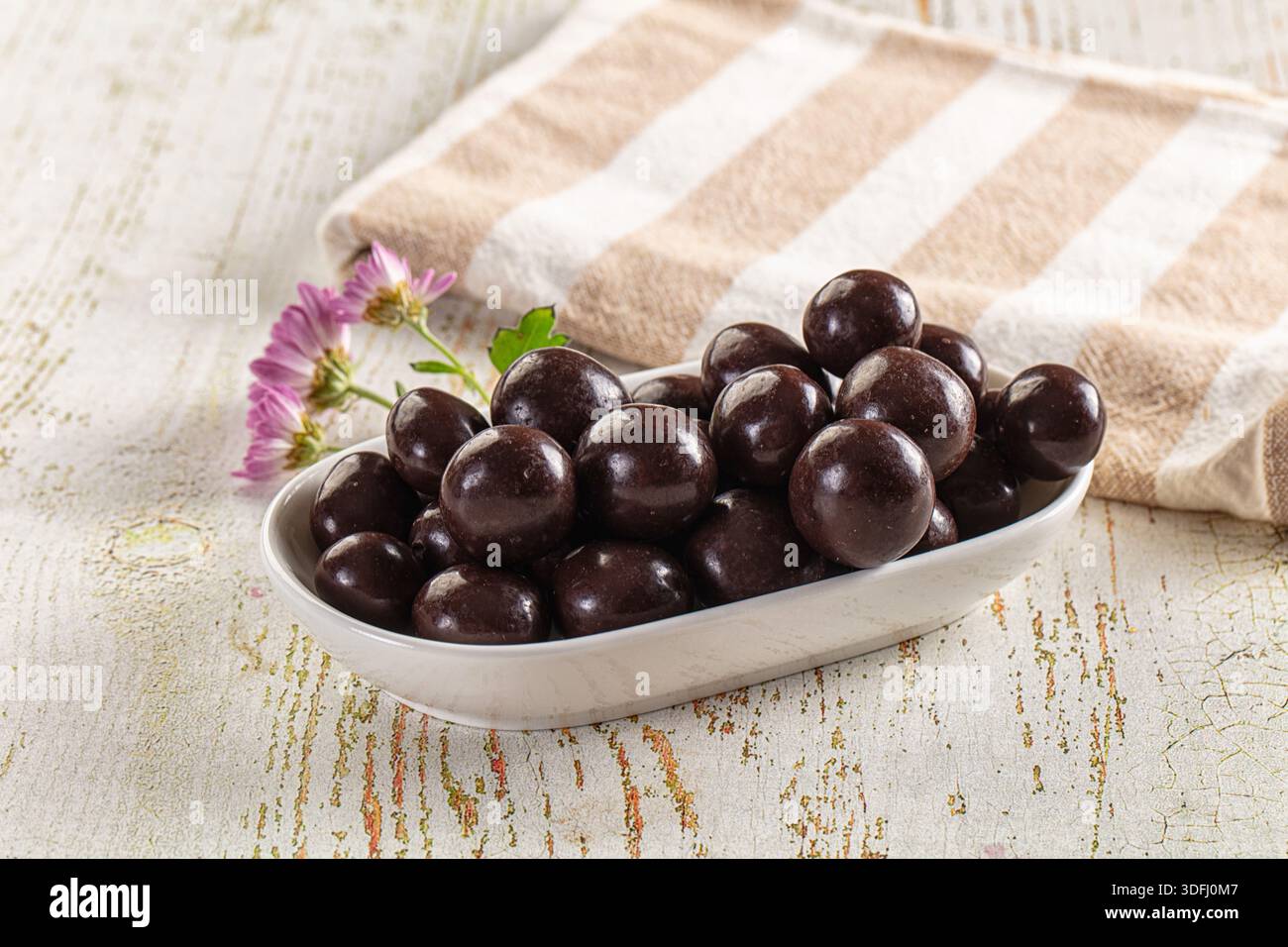 Nut in dark chocolate balls sweet candy Stock Photo - Alamy
