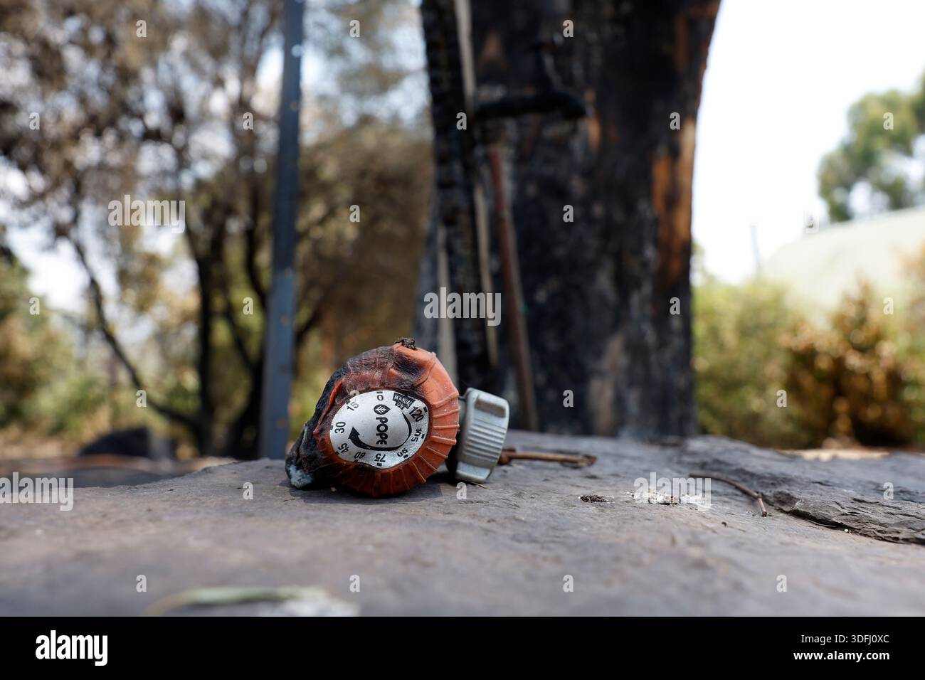 Australia. 13th Jan, 2026. A fire damaged tap watering timer is seen on ...