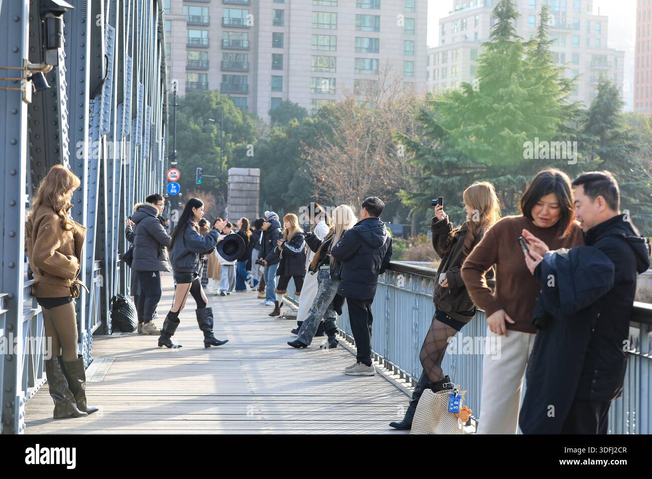 Tourists stroll along the riverside walkway in Hongkou District ...