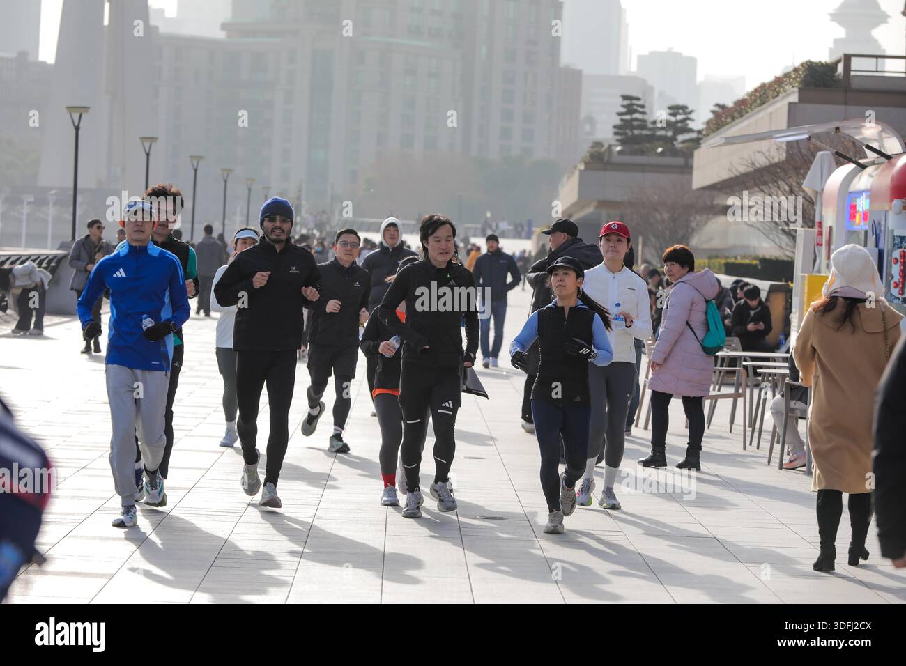 Tourists stroll along the riverside walkway in Hongkou District ...
