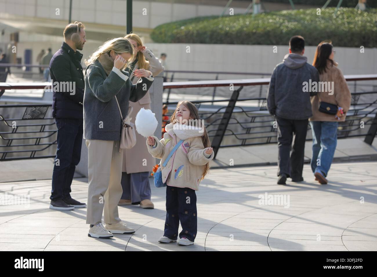 Tourists stroll along the riverside walkway in Hongkou District ...