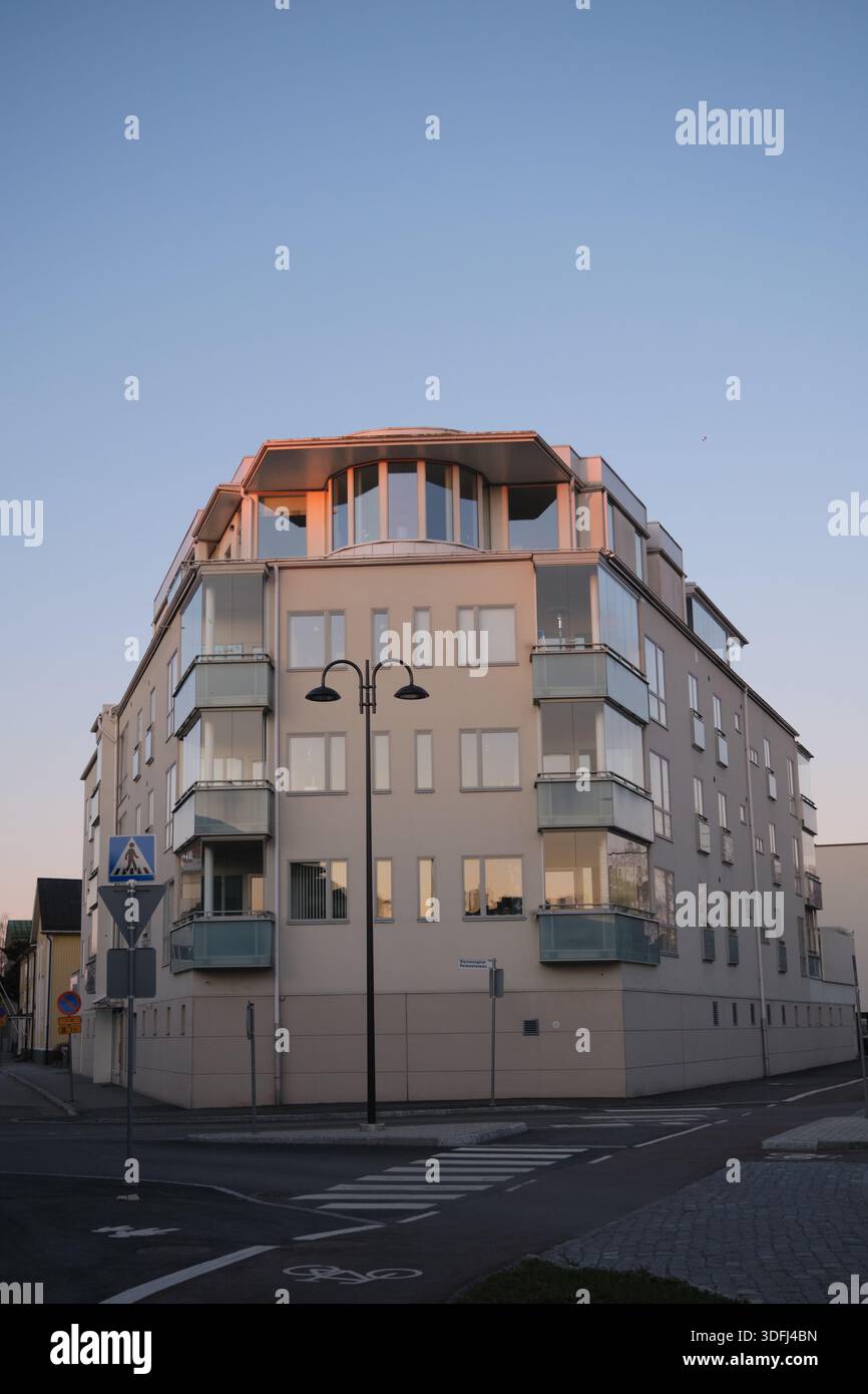 A contemporary residential apartment building stands prominently at a ...