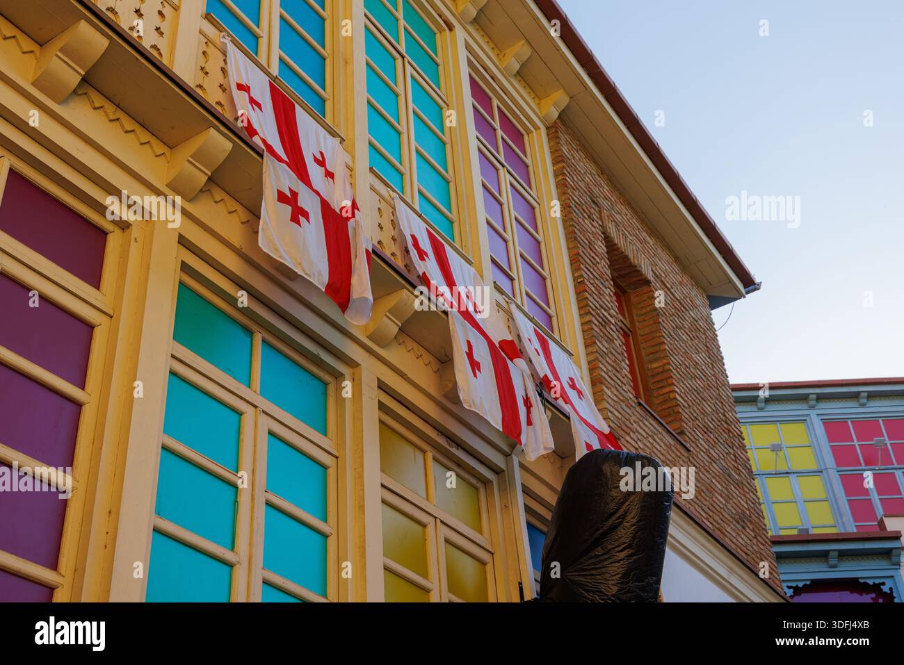 View of Georgian flags draped from windows on streets of central ...