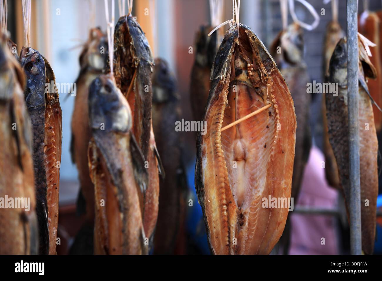 Vendors display and sell traditional cured meats including sausages ...