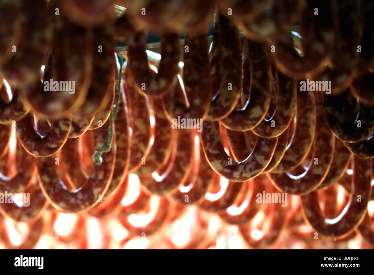 Vendors display and sell traditional cured meats including sausages ...