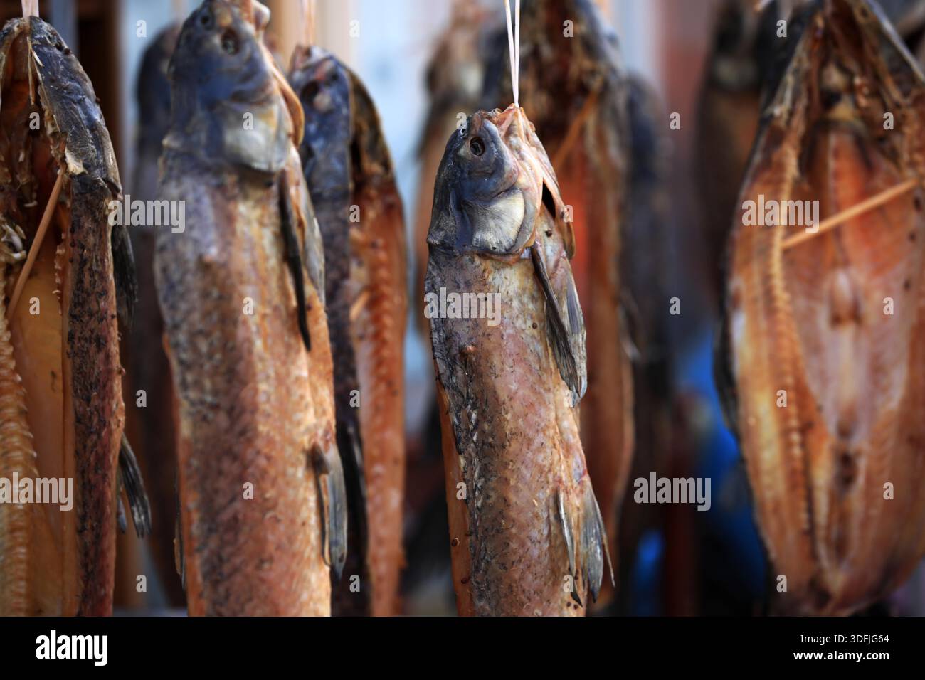 Vendors display and sell traditional cured meats including sausages ...